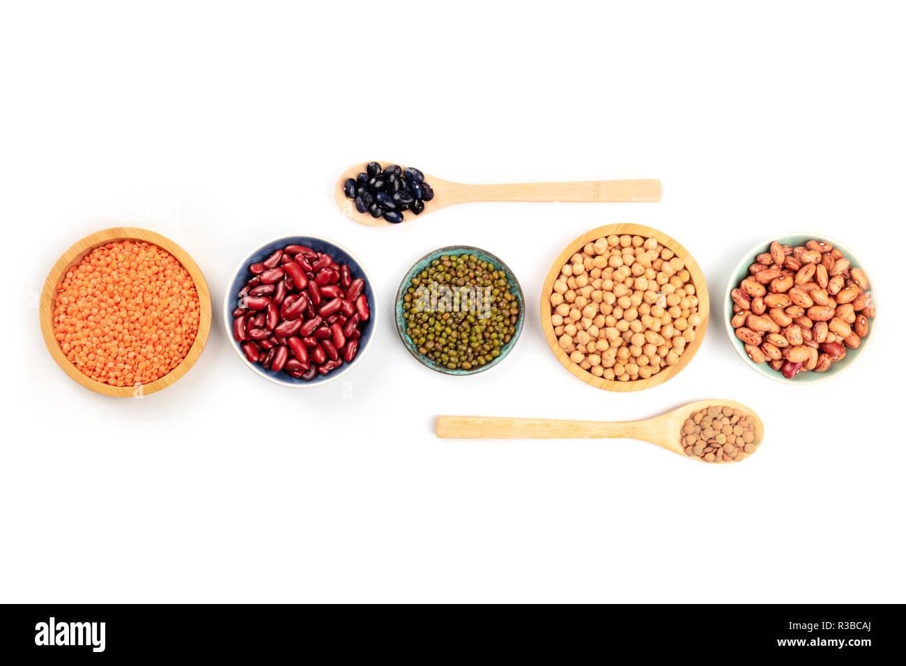 A photo of various types of legumes, shot from the top on a white ...