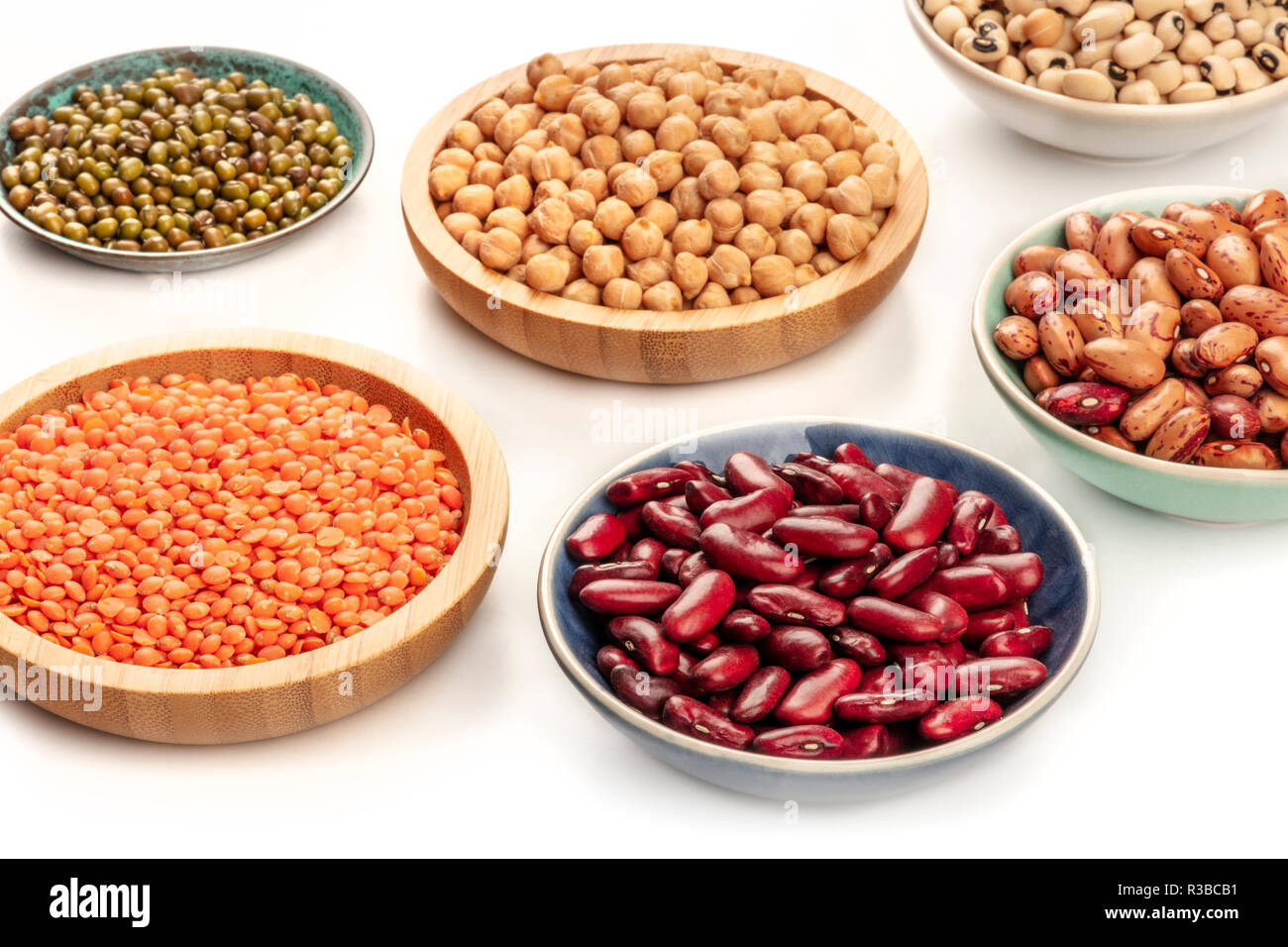 A photo of various types of legumes on a white background. Different ...