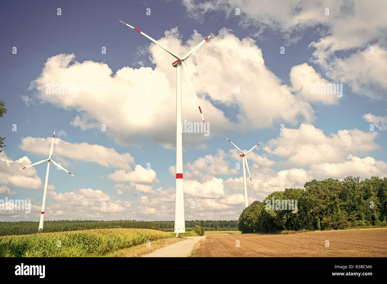 Wind farm in Lower Saxony, Germany. Turbines on field on cloudy blue ...