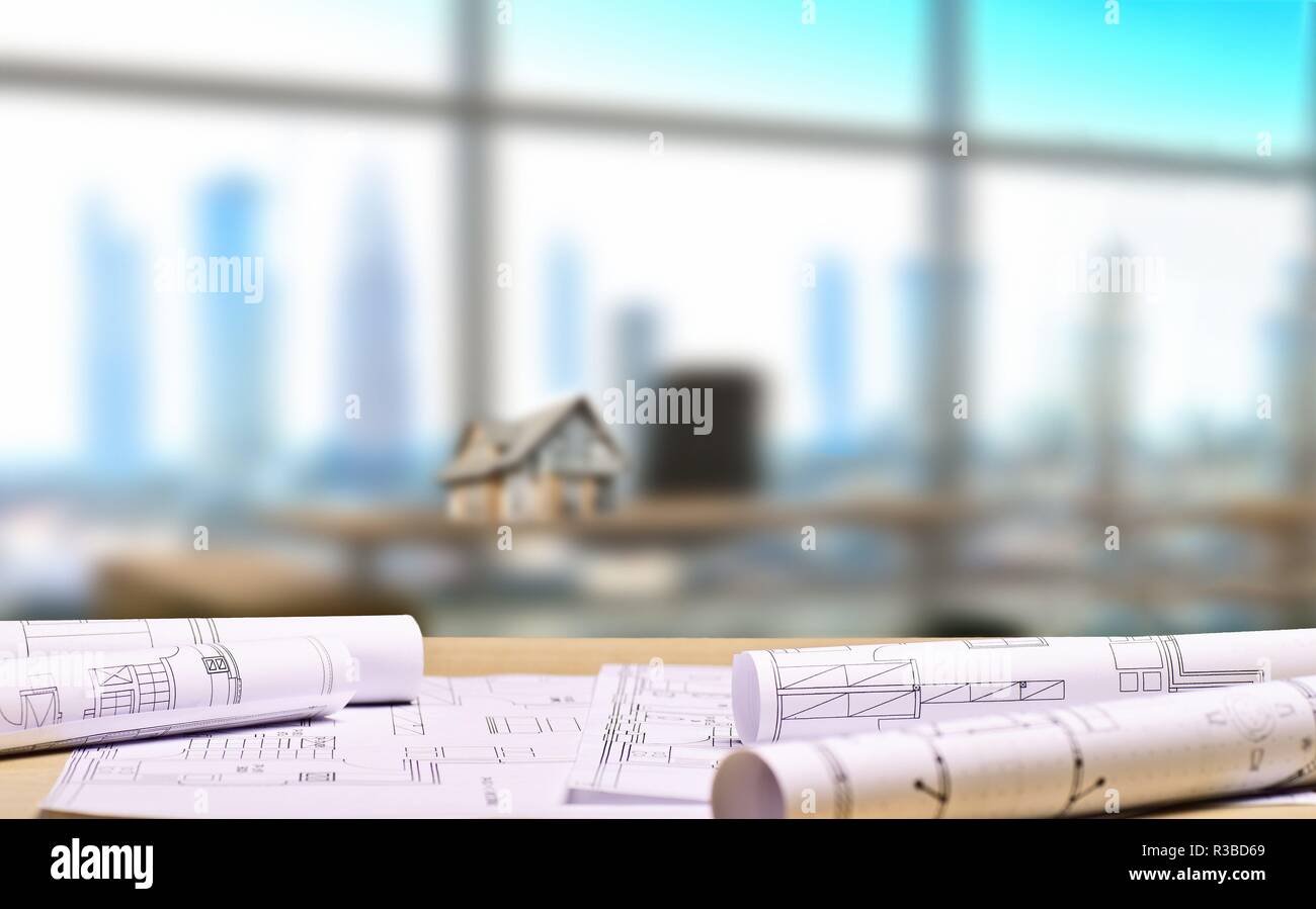 Architectural office with blueprints and an architectural model on a ...