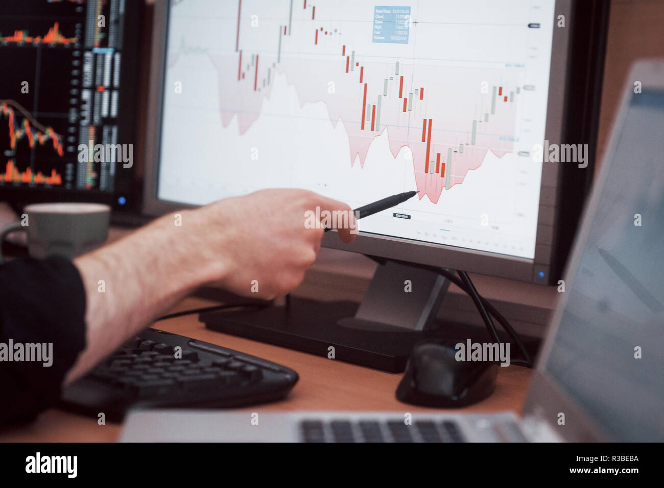Analyzing data. Close-up of young businessman pointing on the data ...