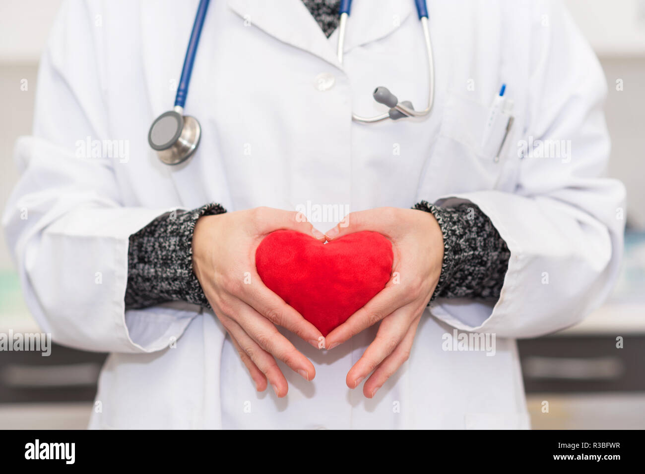 Doctor holding a red heart shape Stock Photo - Alamy