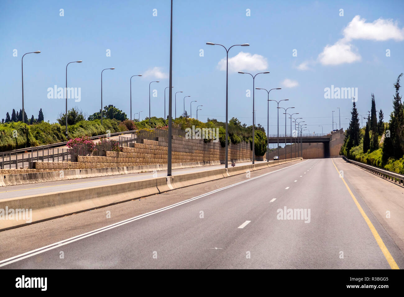 Highway with signs and vehicles in traffic from Jerusalem to Haifa on a ...