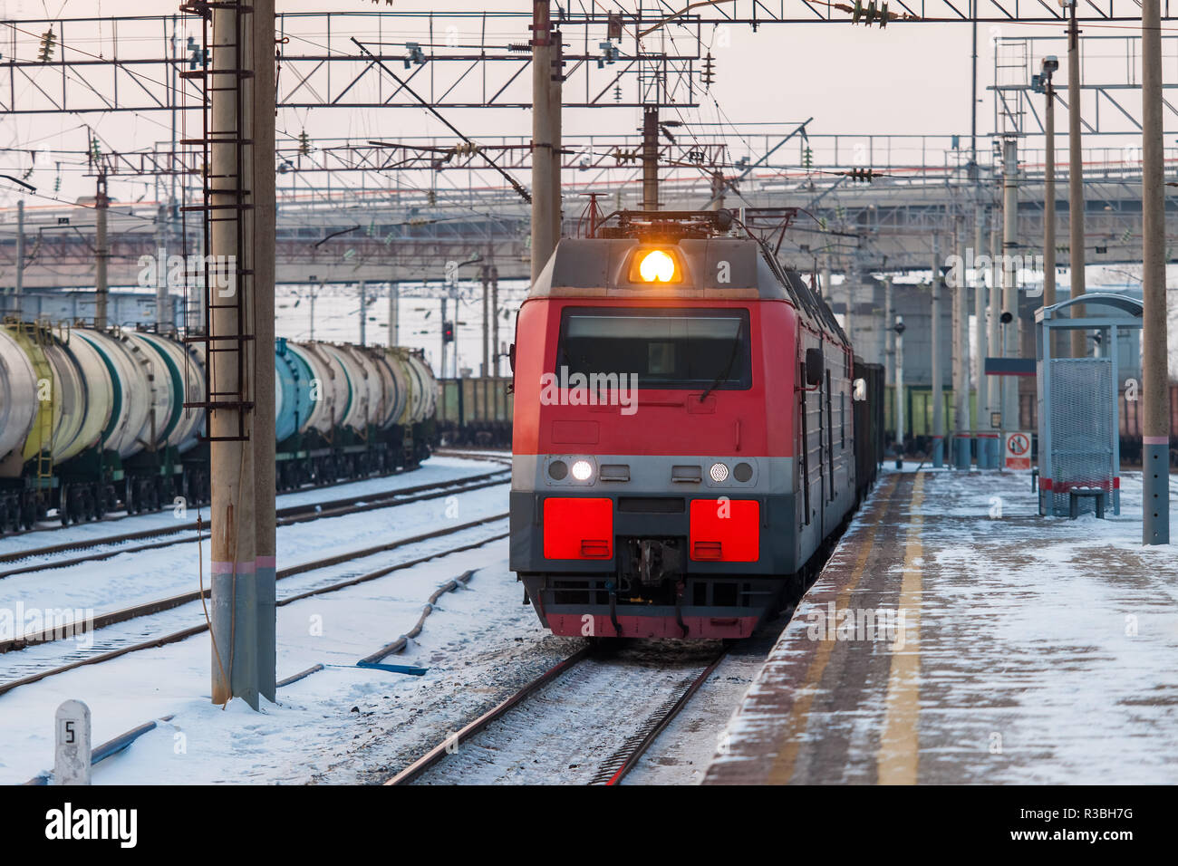 Electric train passing a platform at the station Stock Photo - Alamy