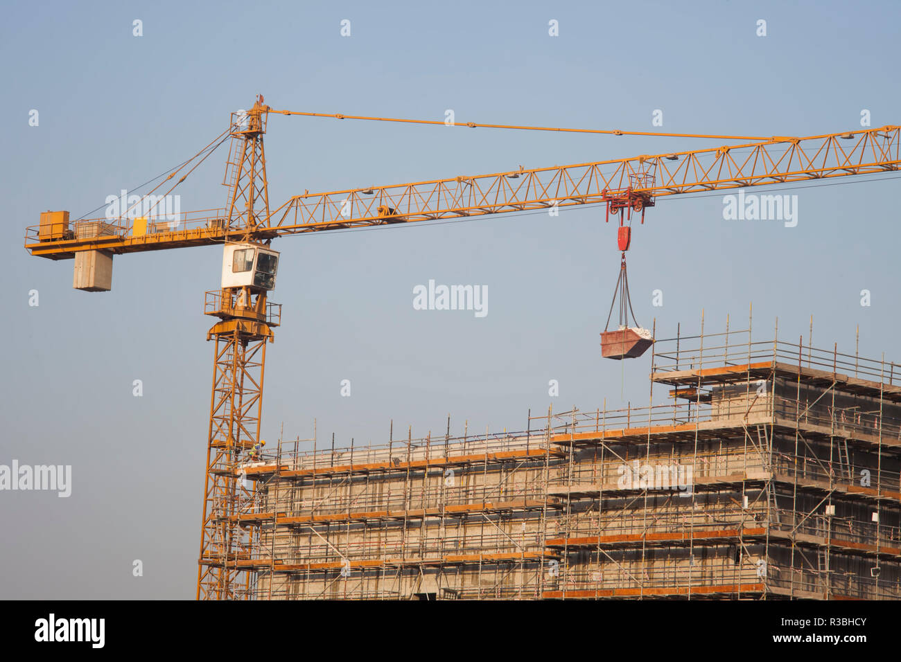 construction crane lifting cargo. industry Stock Photo - Alamy