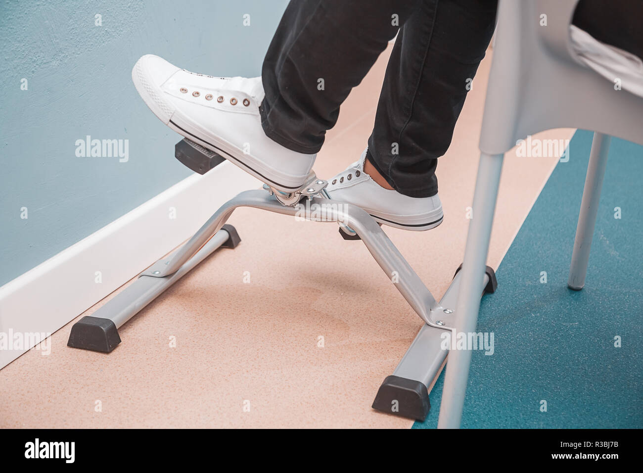 Close-up of female patient on feet moving with walker. Medical and ...