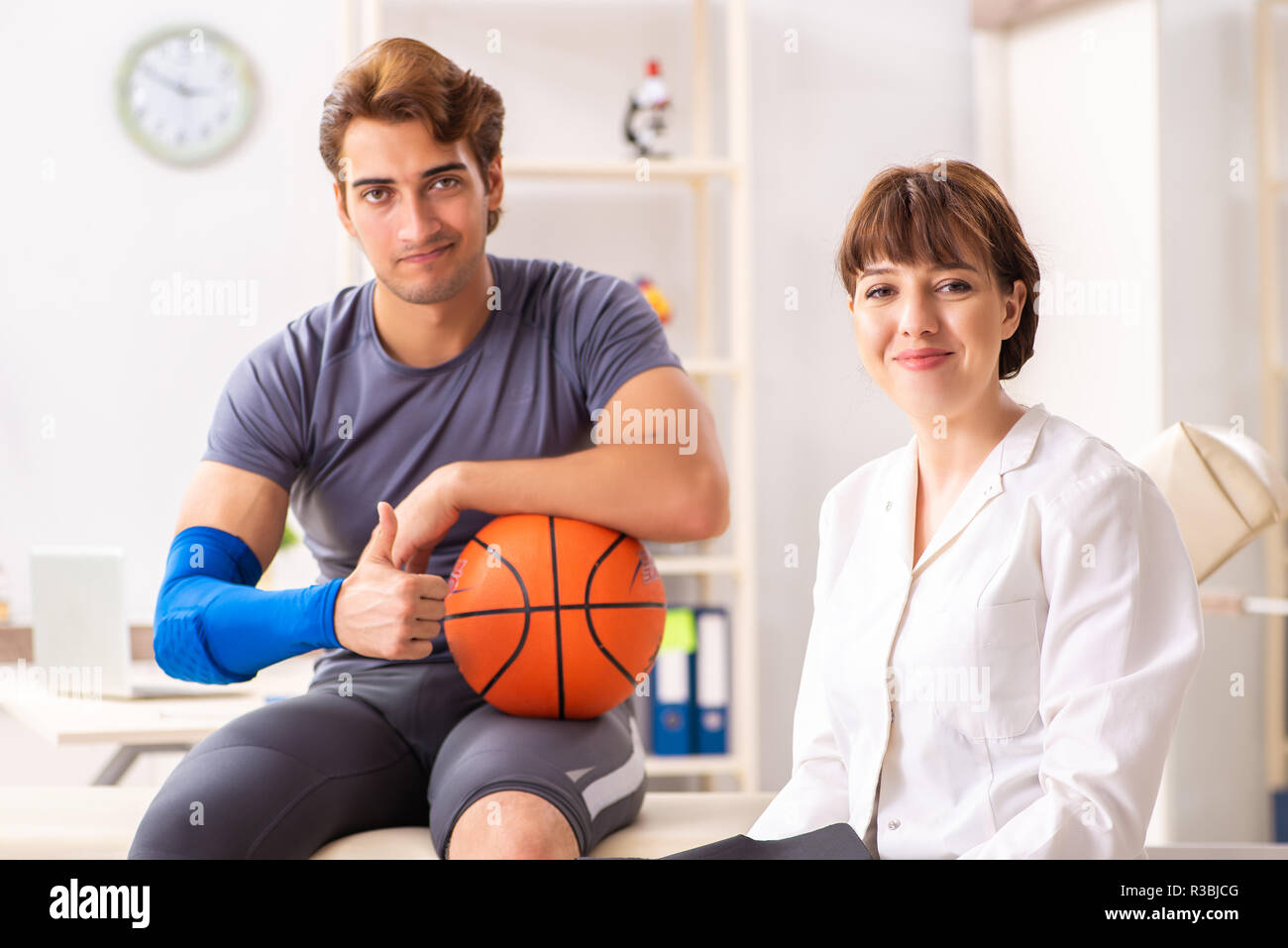 Handsome basketball player visiting female doctor traumatologist Stock ...