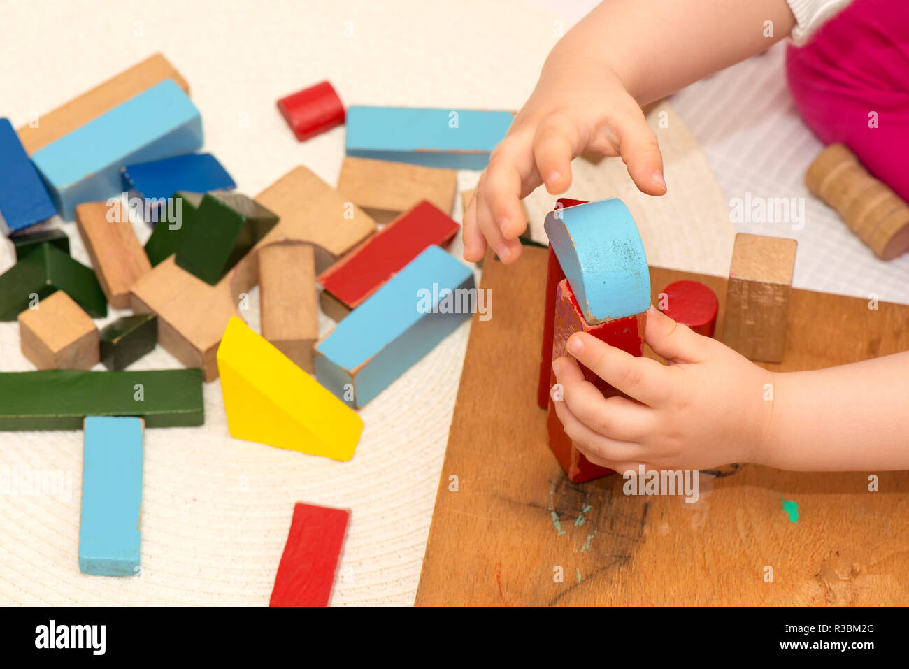 Child playing with wood old building blocks Stock Photo - Alamy