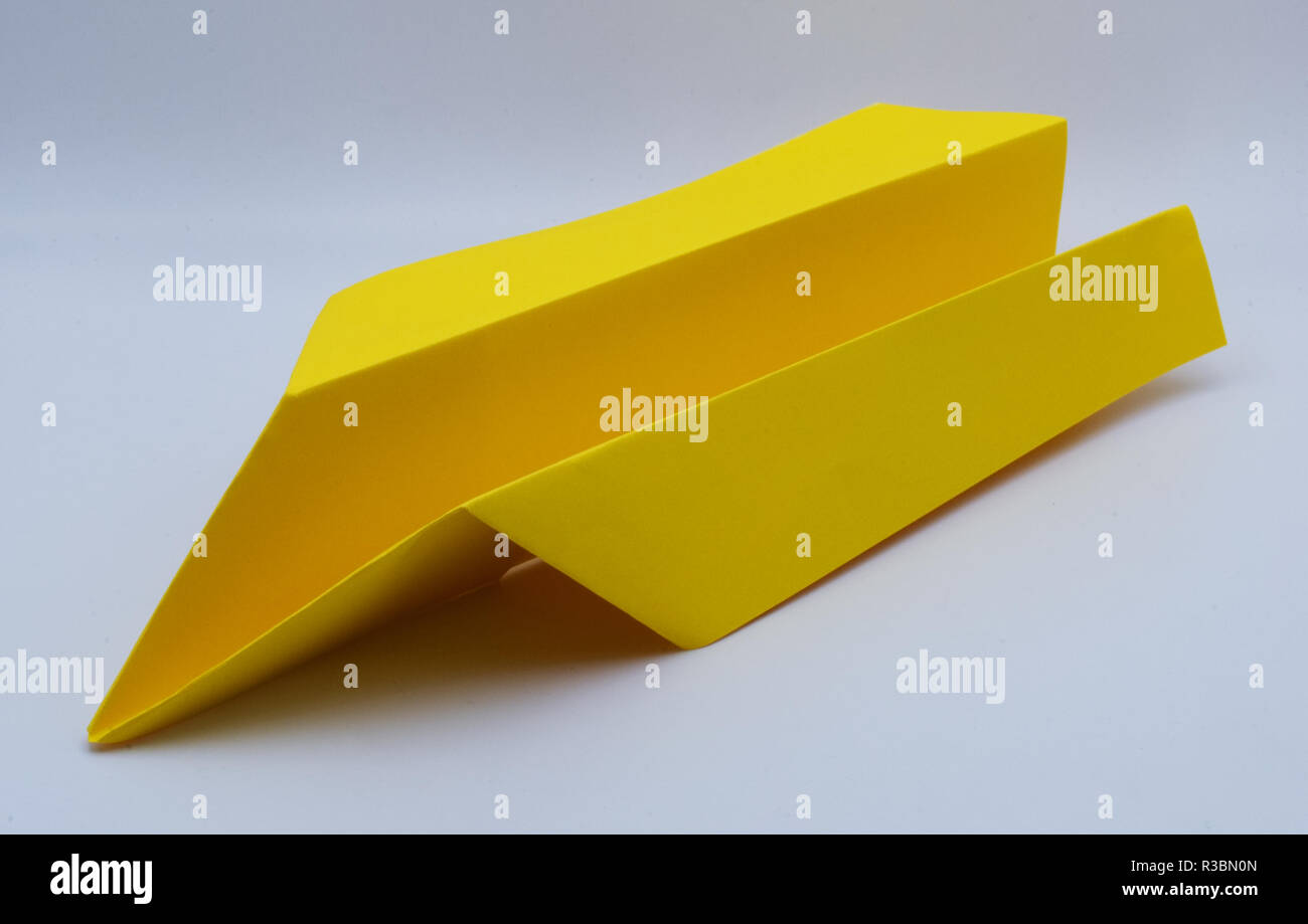 Yellow paper airplane Stock Photo - Alamy