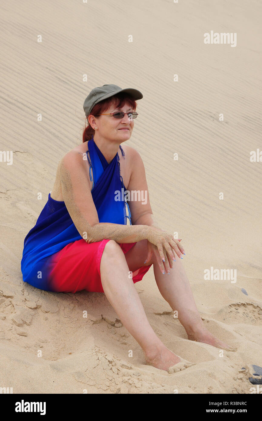 woman sitting in the sand Stock Photo - Alamy