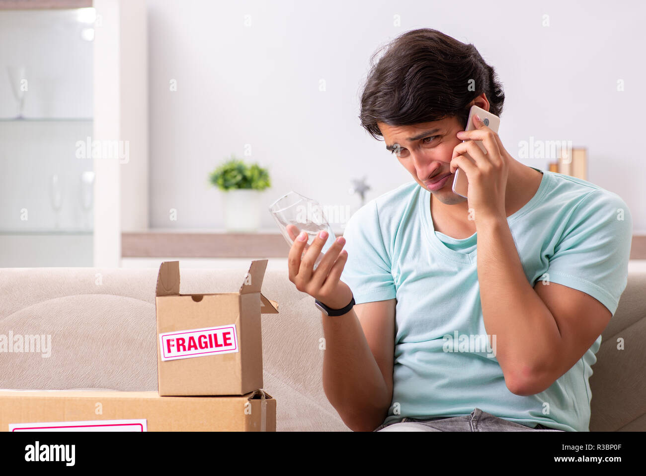 Man opening fragile parcel ordered from internet Stock Photo - Alamy