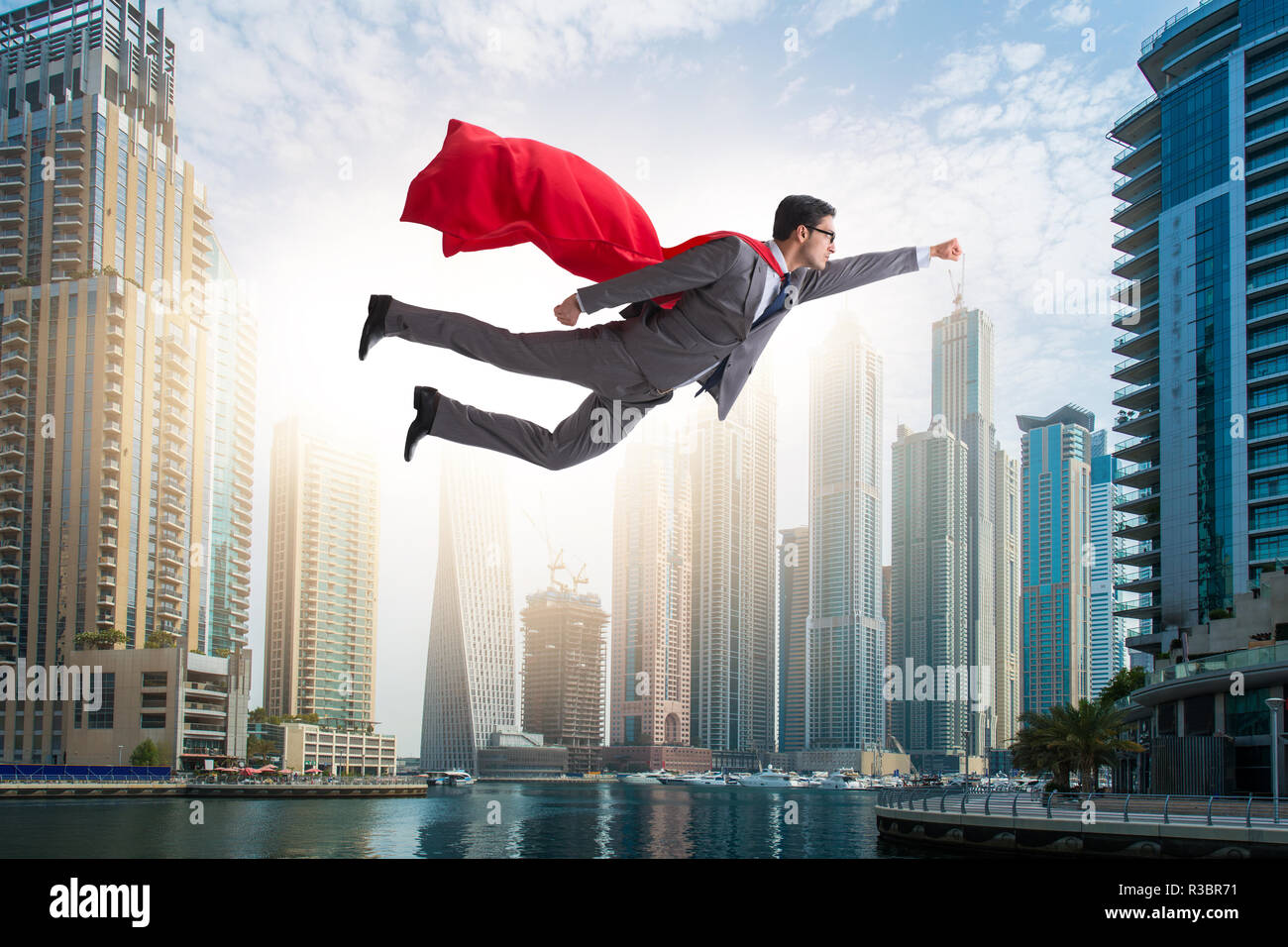 Superhero businessman flying over the city Stock Photo - Alamy