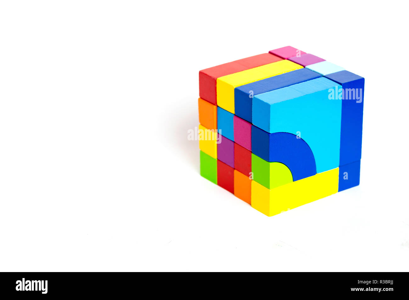 Colored wooden blocks, cubes, build on a light white background. A cube ...