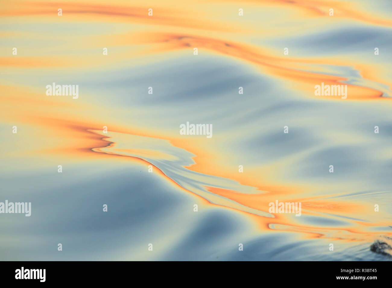 Sunset colors and patterns on small waves in water Stock Photo - Alamy