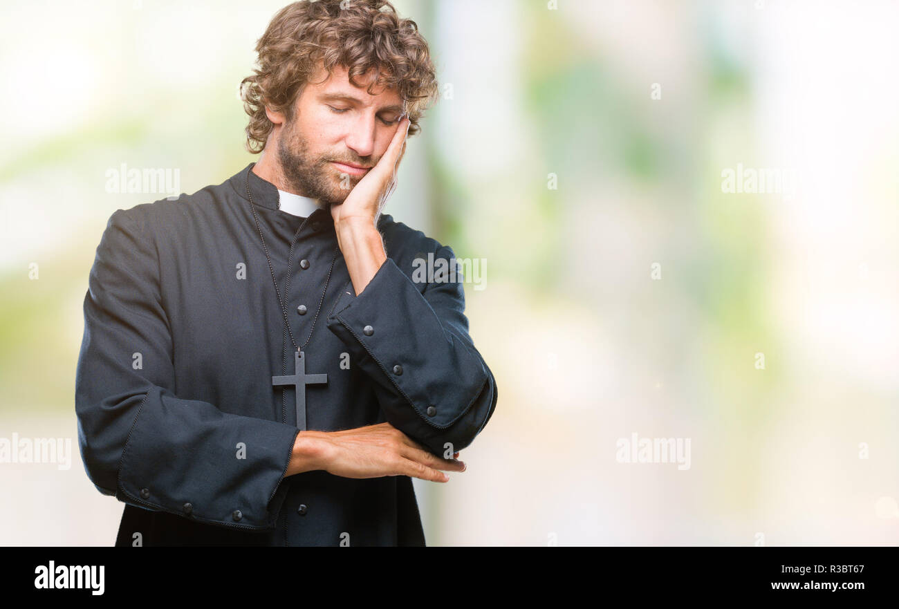 Handsome hispanic catholic priest man over isolated background thinking ...