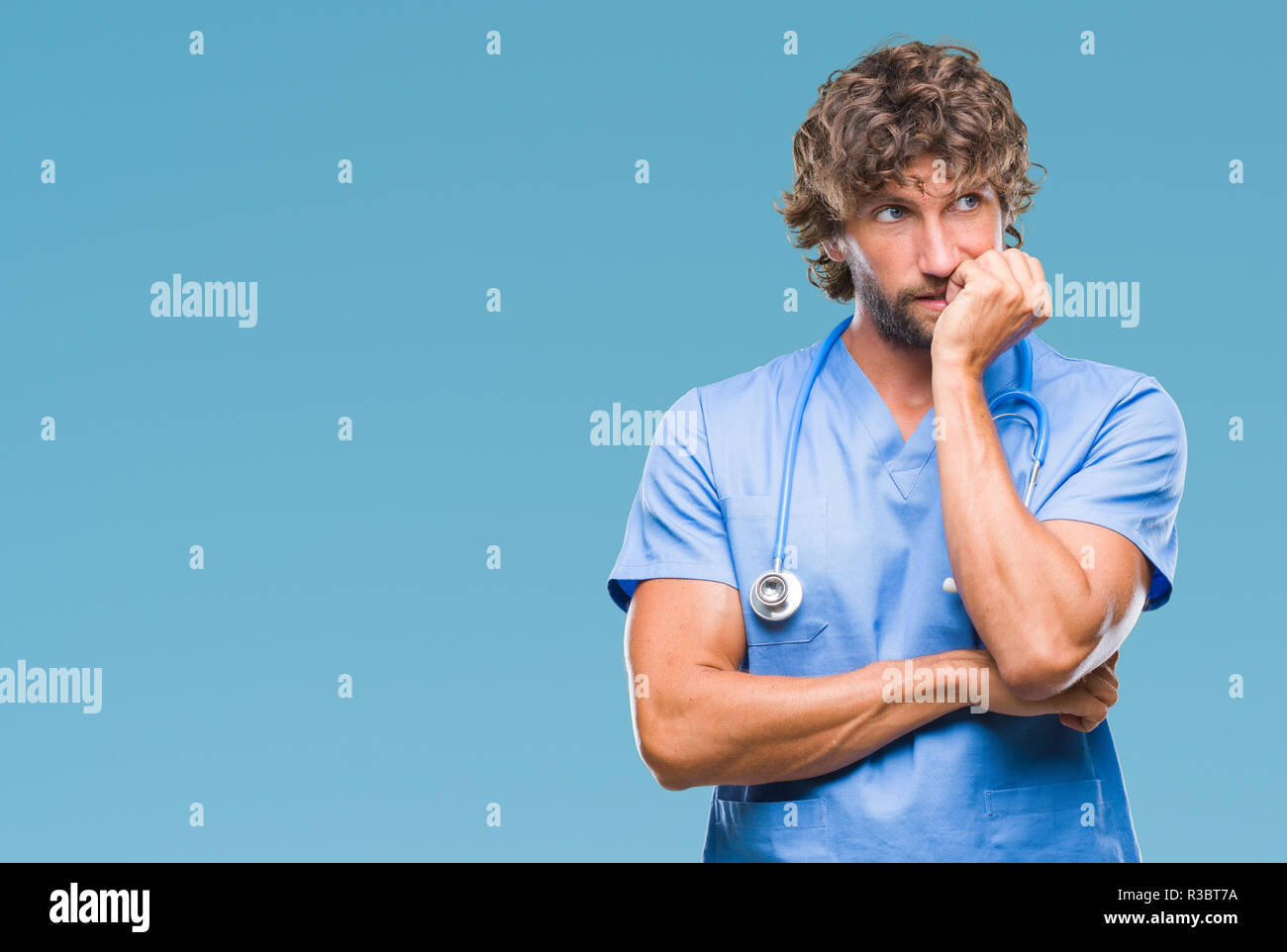 Handsome hispanic surgeon doctor man over isolated background looking ...