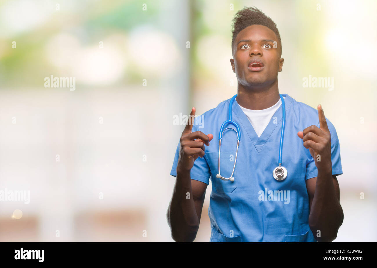 Young african american doctor man over isolated background wearing ...