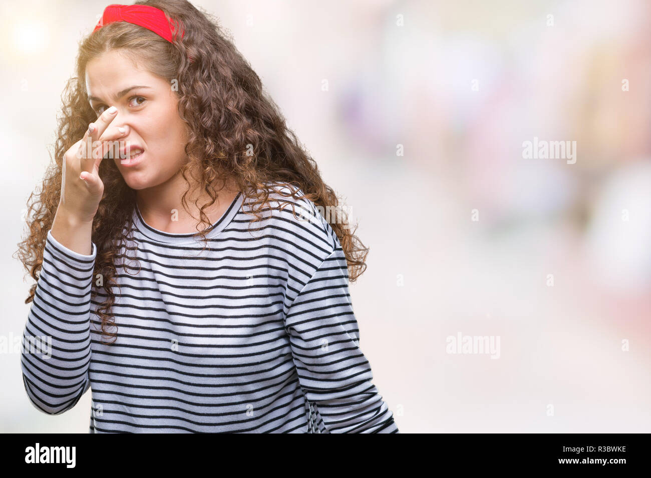 Beautiful brunette curly hair young girl wearing stripes sweater over ...