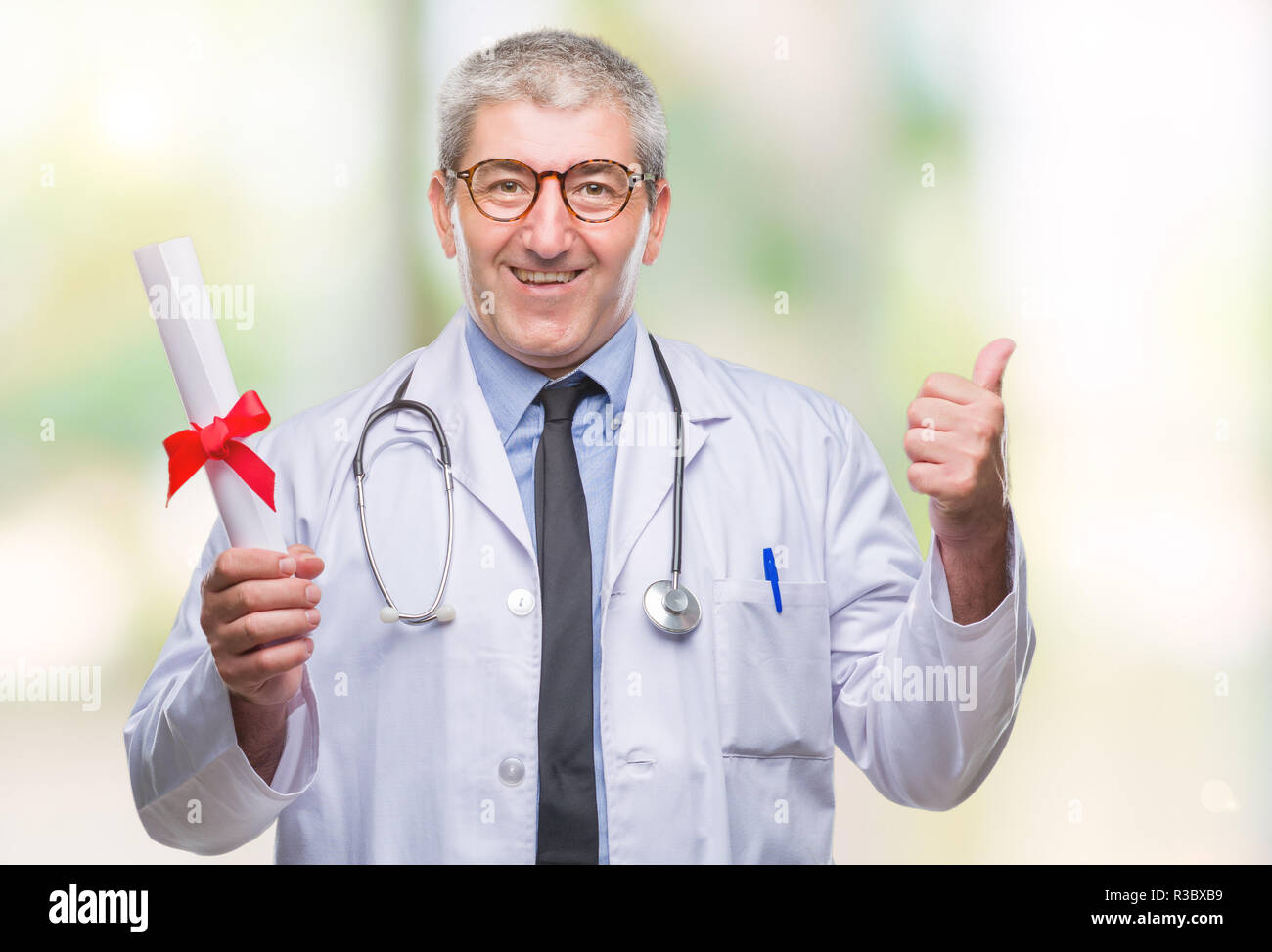 Handsome senior doctor man holding degree paper over isolated ...