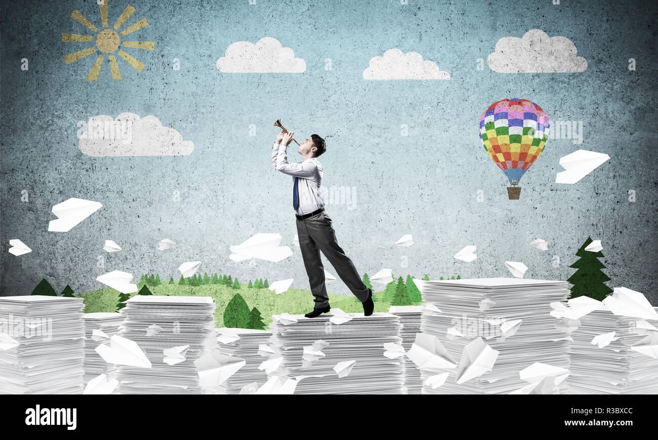 Happy businessman playing fife Stock Photo - Alamy