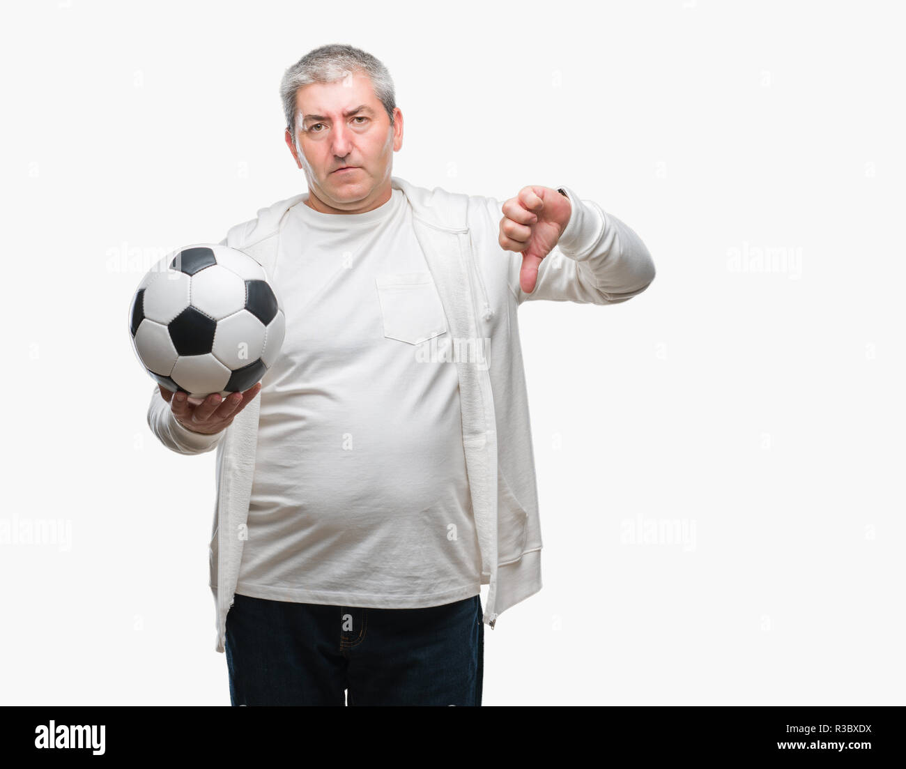 Handsome senior man holding soccer football ball over isolated ...
