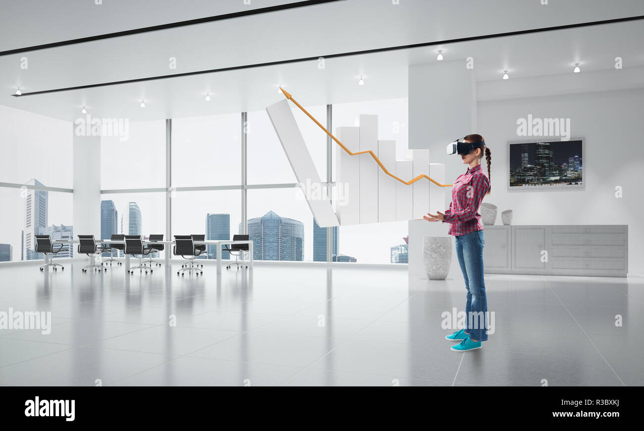 Girl in office interior in virtual reality mask using innovative ...
