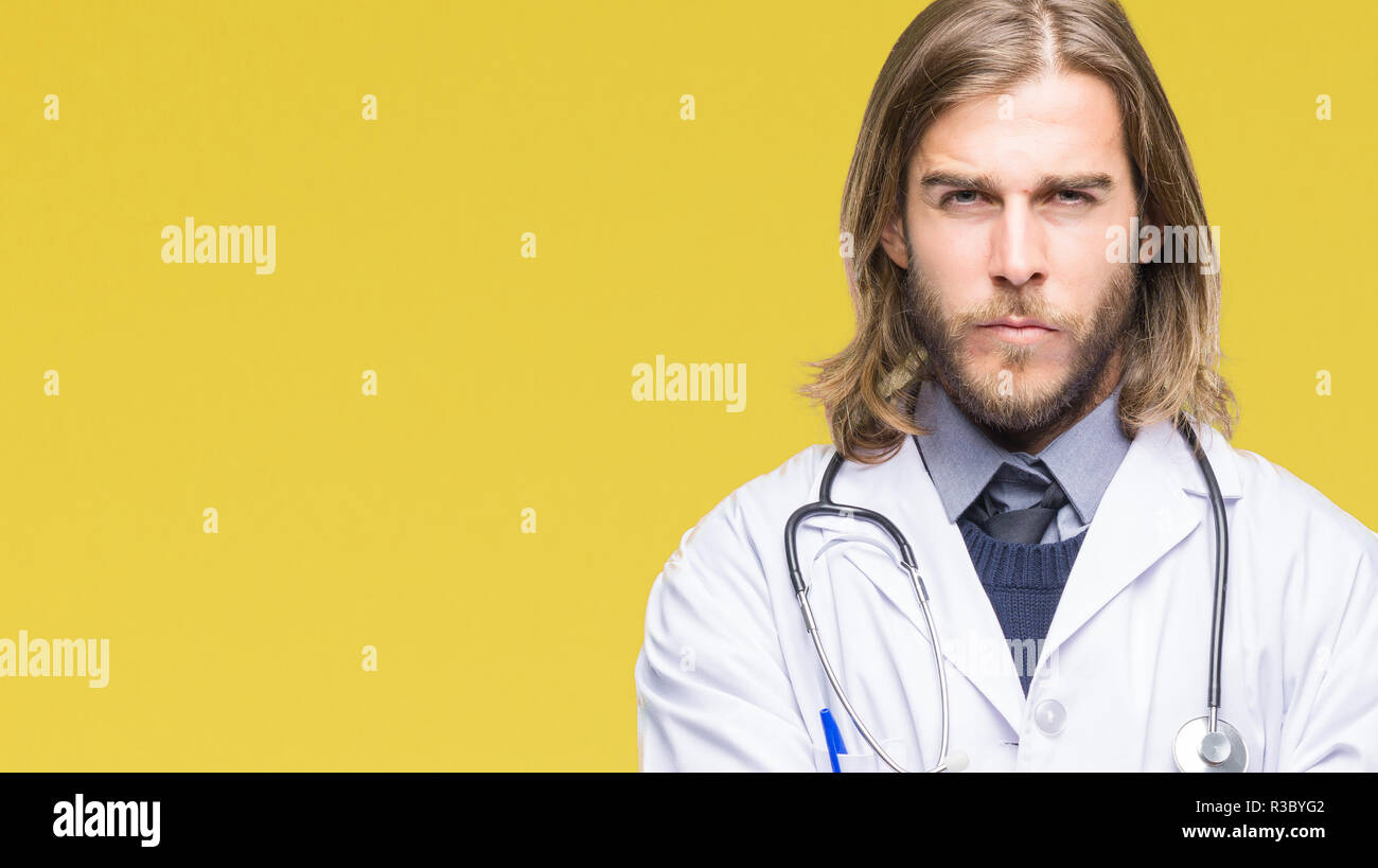 Young handsome doctor man with long hair over isolated background ...