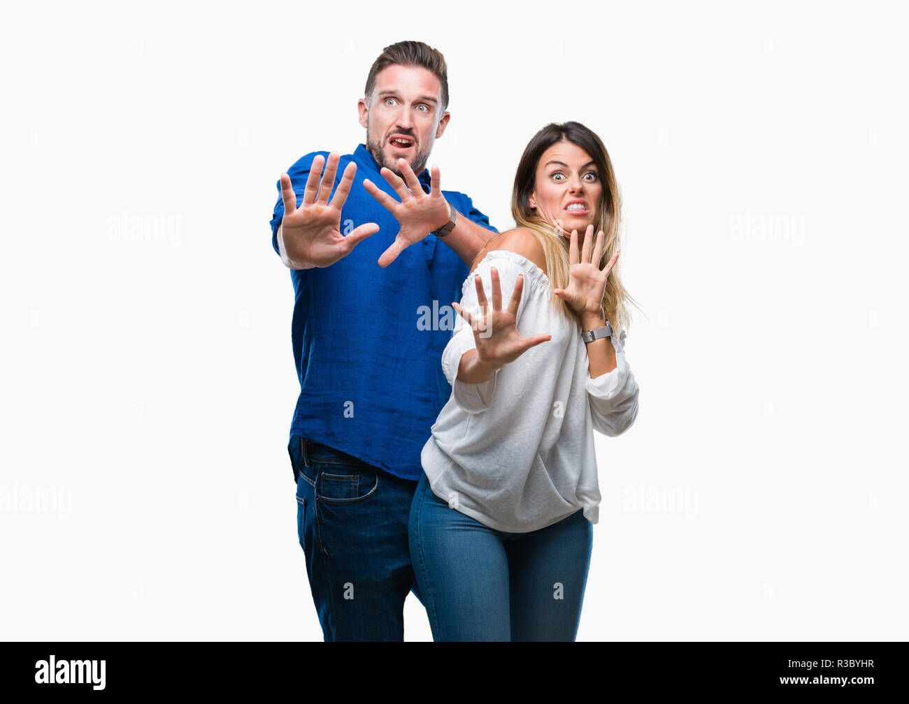 Young couple in love over isolated background afraid and terrified with ...