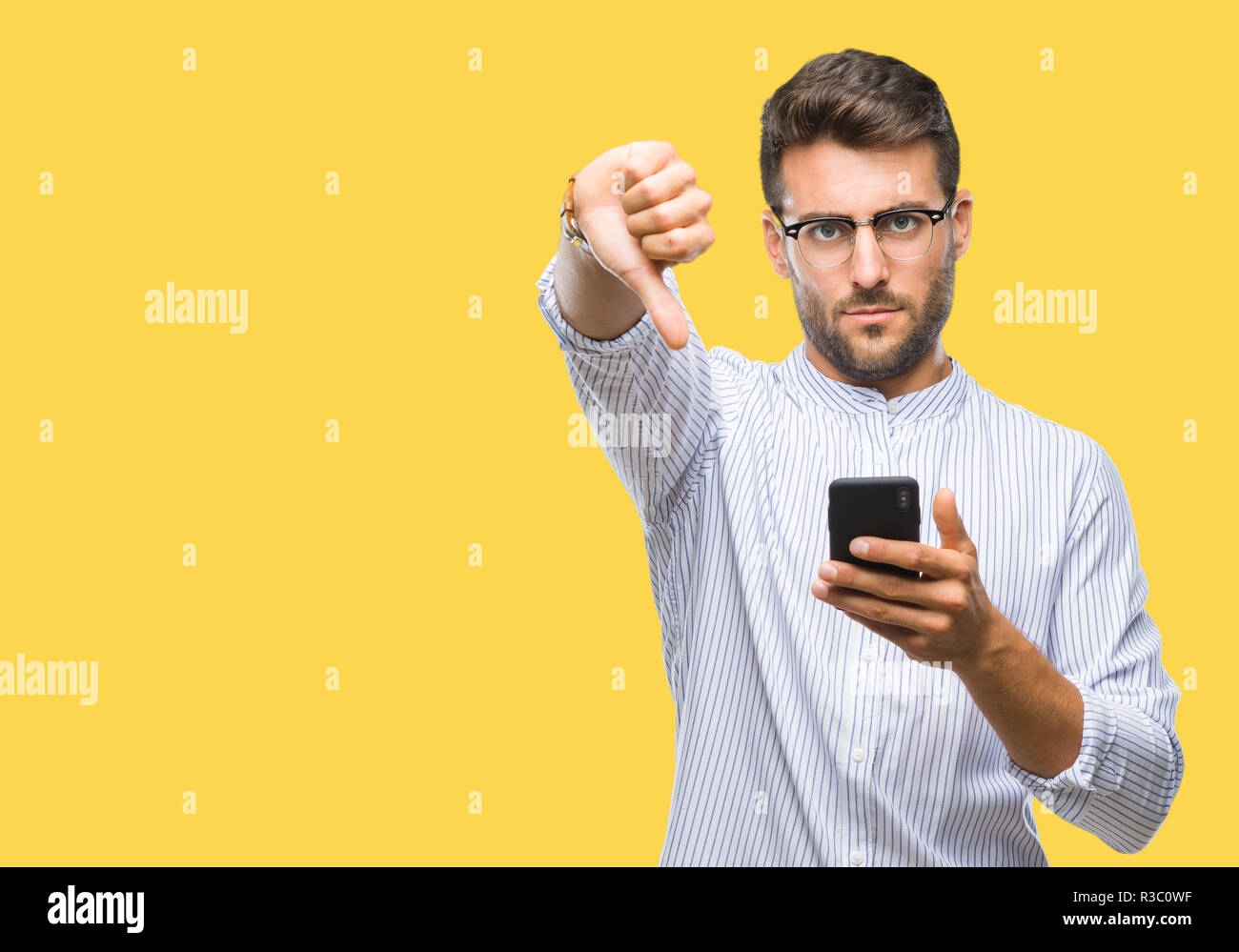 Young handsome man texting using smartphone over isolated background ...