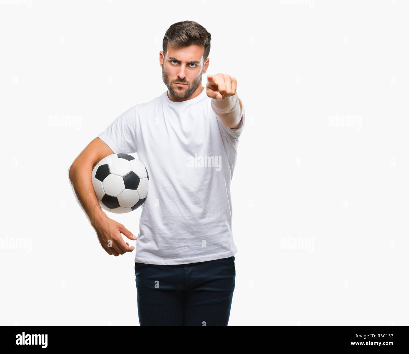 Young handsome man holding soccer football ball over isolated ...