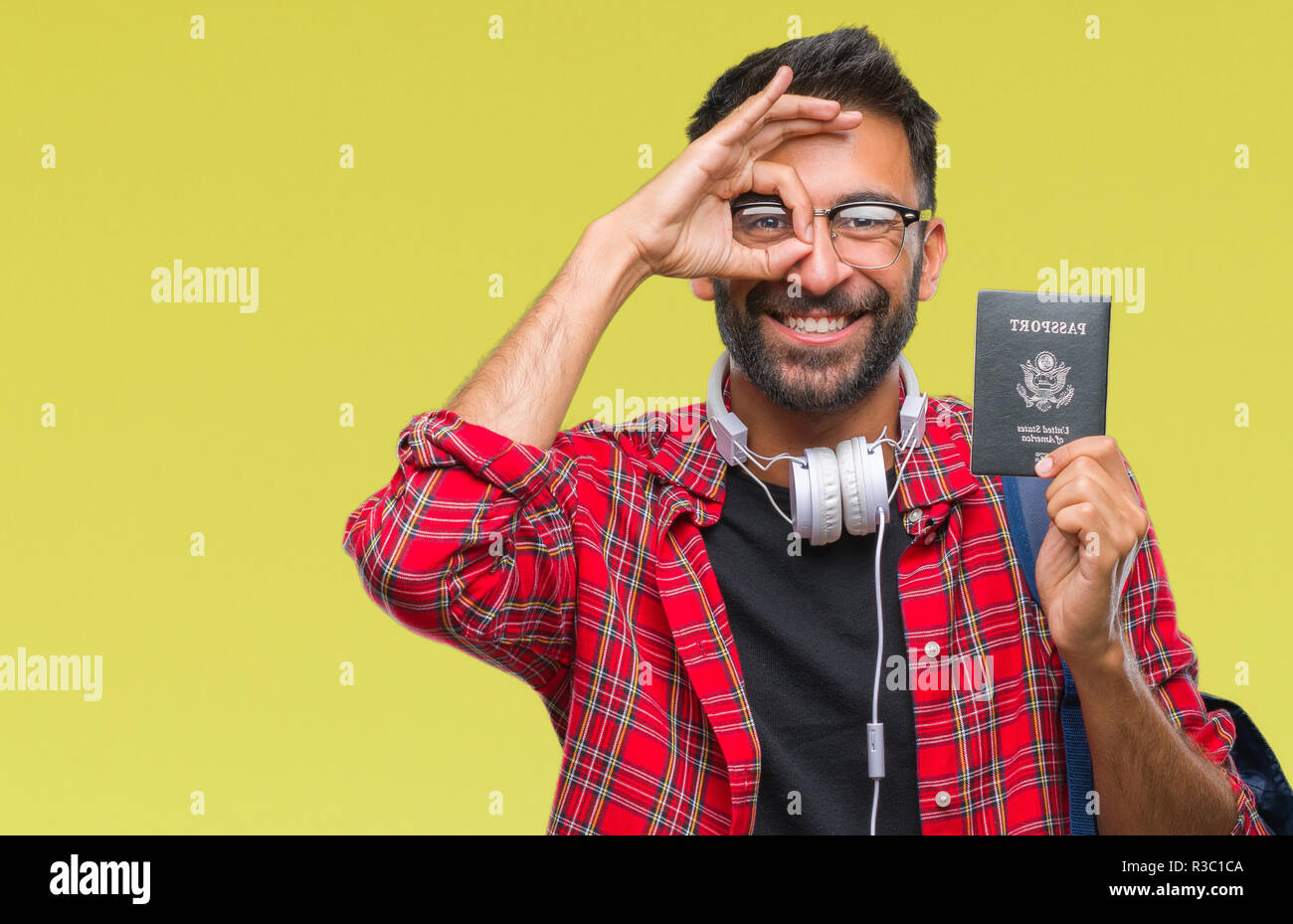 Adult hispanic student man holding passport of america over isolated ...