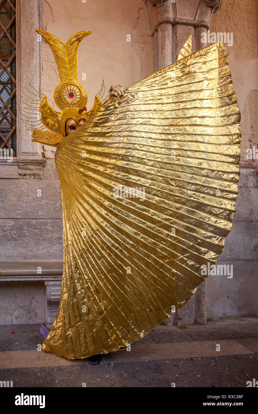 Woman dressed like a golden angel at the Carnival in Venice, Italy ...