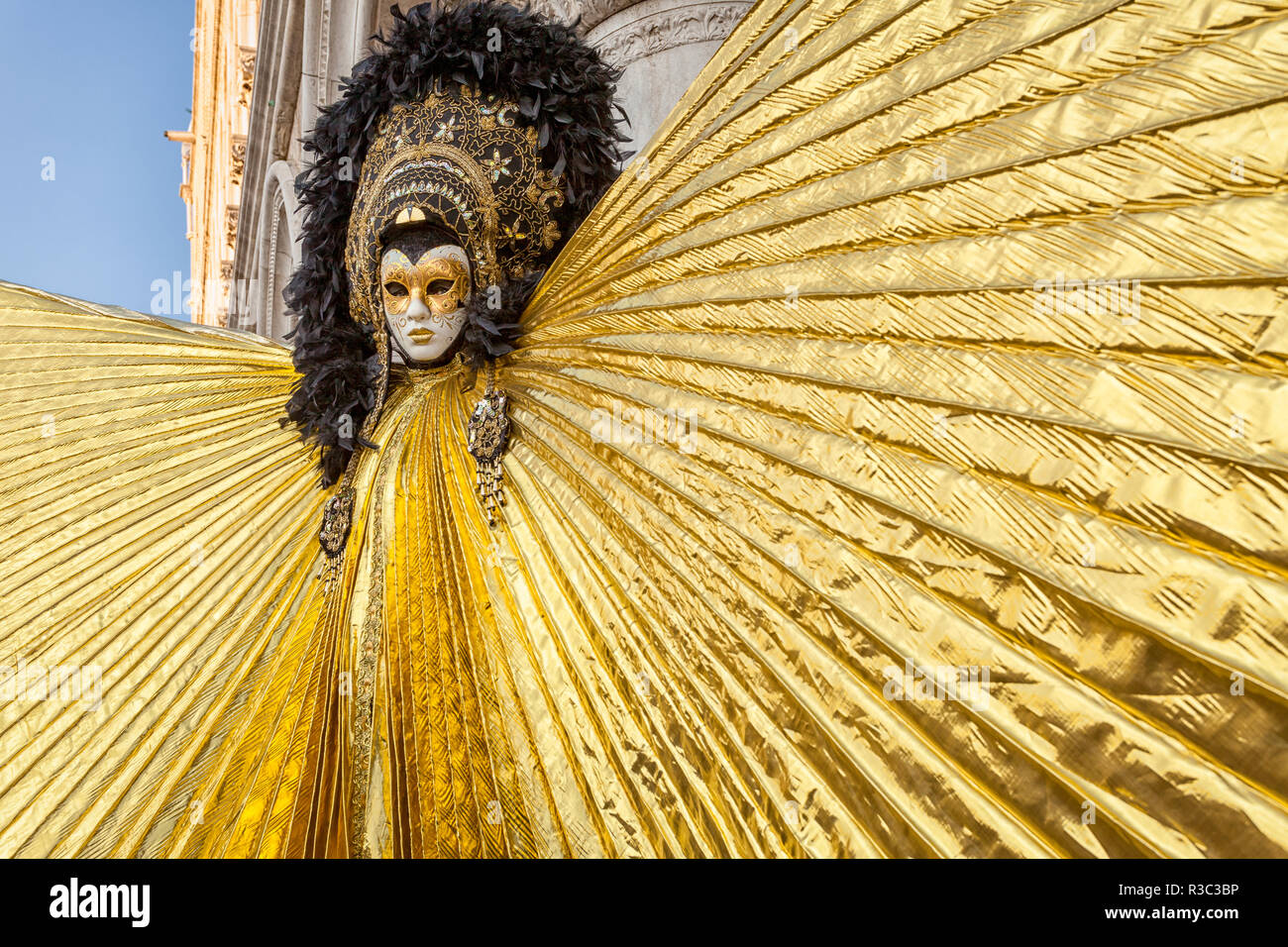 Woman dressed like a golden angel at the Carnival in Venice, Italy ...