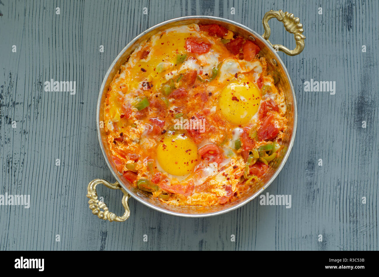 Traditional turkish food menemen made by eggs, pepper and tomatoes ...