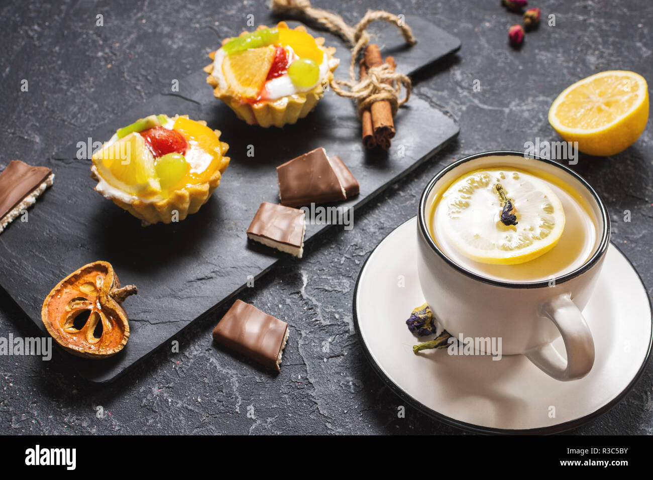 Cup of tea and cookies on black stone background. Good morning concept ...