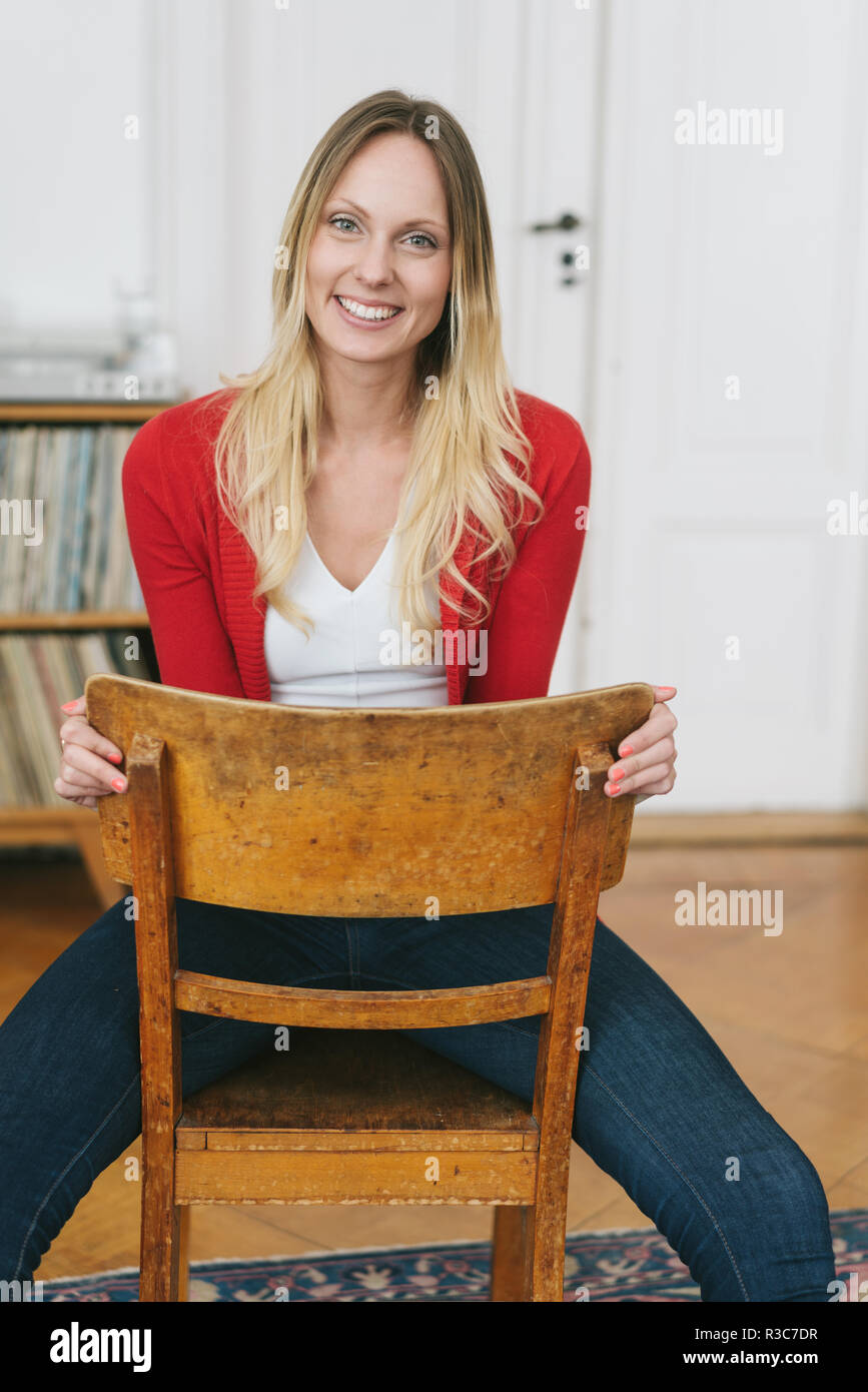 Portrait of a woman resting on a chair and smiling hi-res stock ...