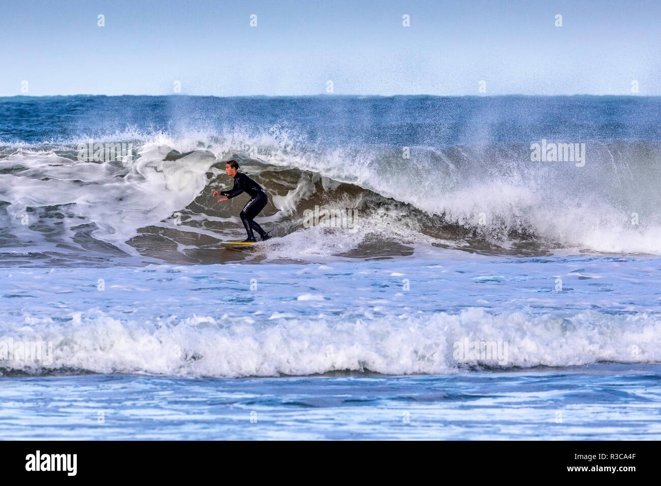 Surfer inside the tube of a wave on Porthmeor beach, St Ives, Cornwall ...