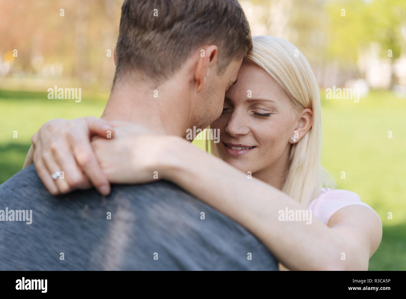 Woman arms around neck man hi-res stock photography and images - Alamy