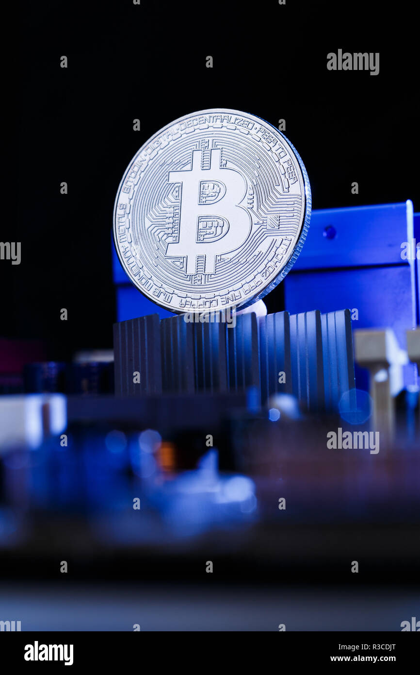 Photo of coin bitcoin and processor on blue, black background Stock ...