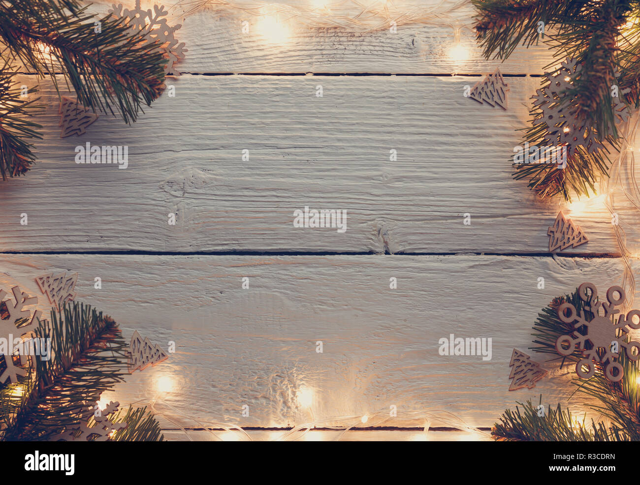 Photo of Christmas wooden gray table with burning garland, spruce ...