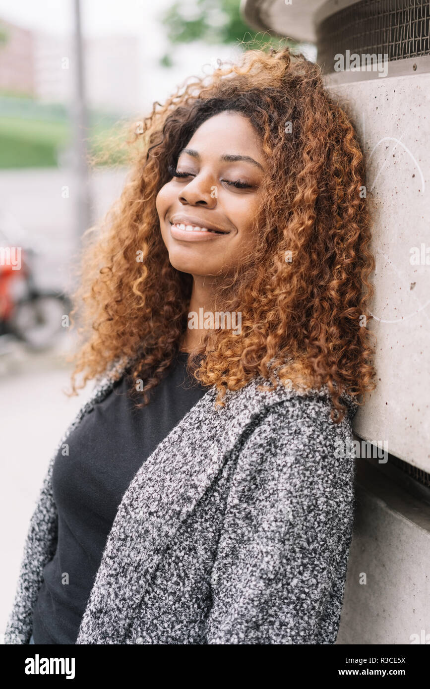 Street Portrait Of Young Dreamy Curly Haired African American Woman