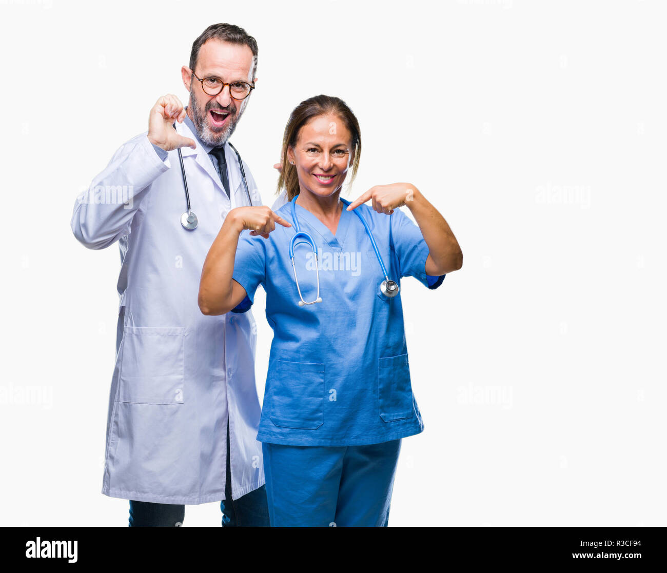 Middle age hispanic doctors partners couple wearing medical uniform ...