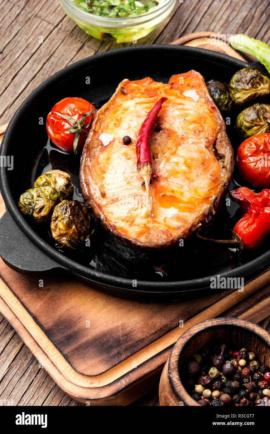 Baked salmon with tomato, pepper and cabbage.Fish steak with vegetable ...