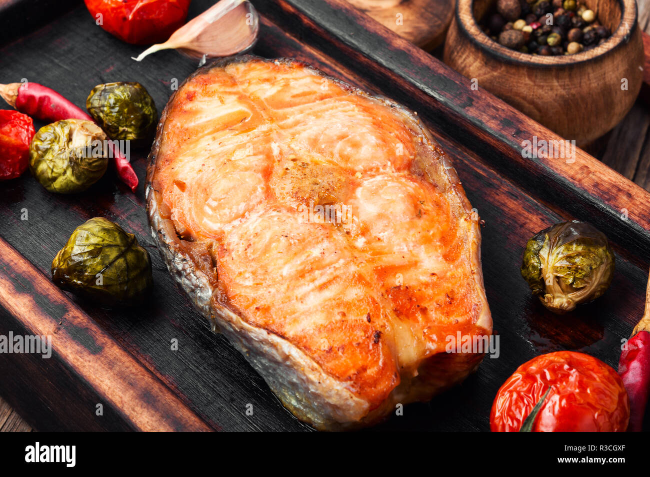 Grilled salmon with tomato, pepper and cabbage.Fish steak with ...