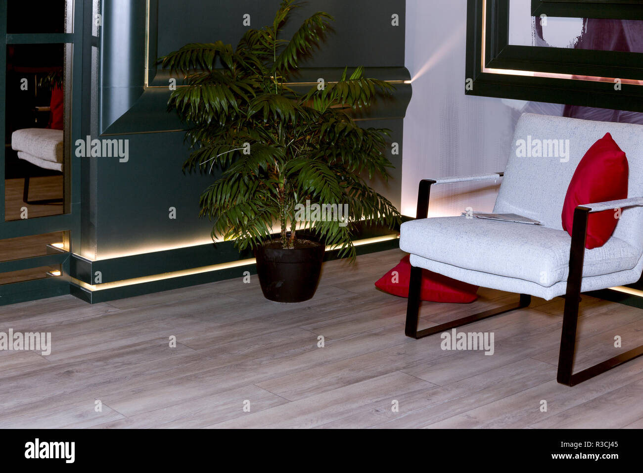 gray armchair with red pillows in the interior Stock Photo - Alamy