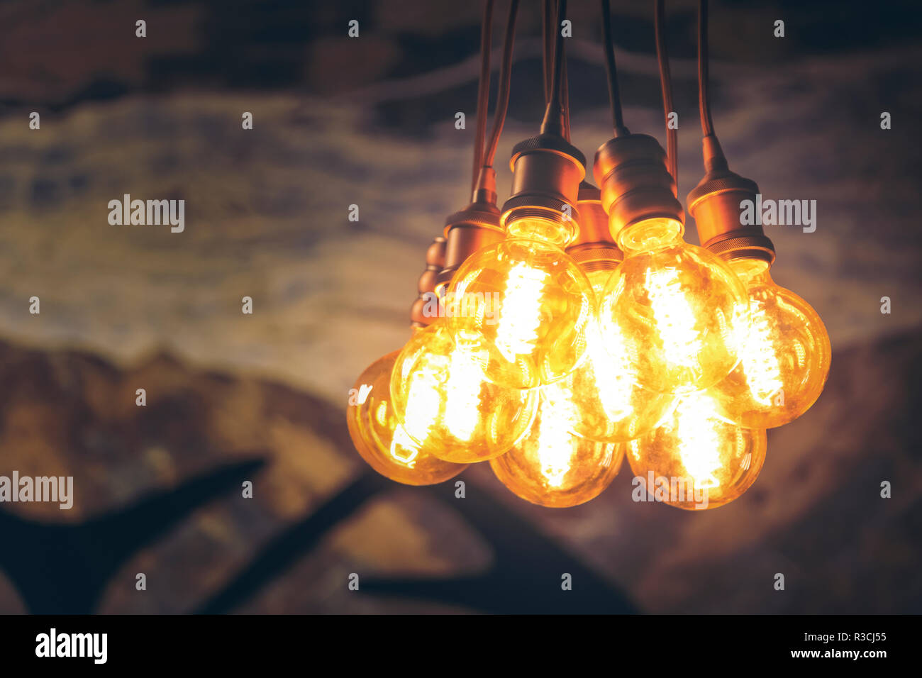 burning light bulbs against a dark wall. Shallow DOF Stock Photo - Alamy