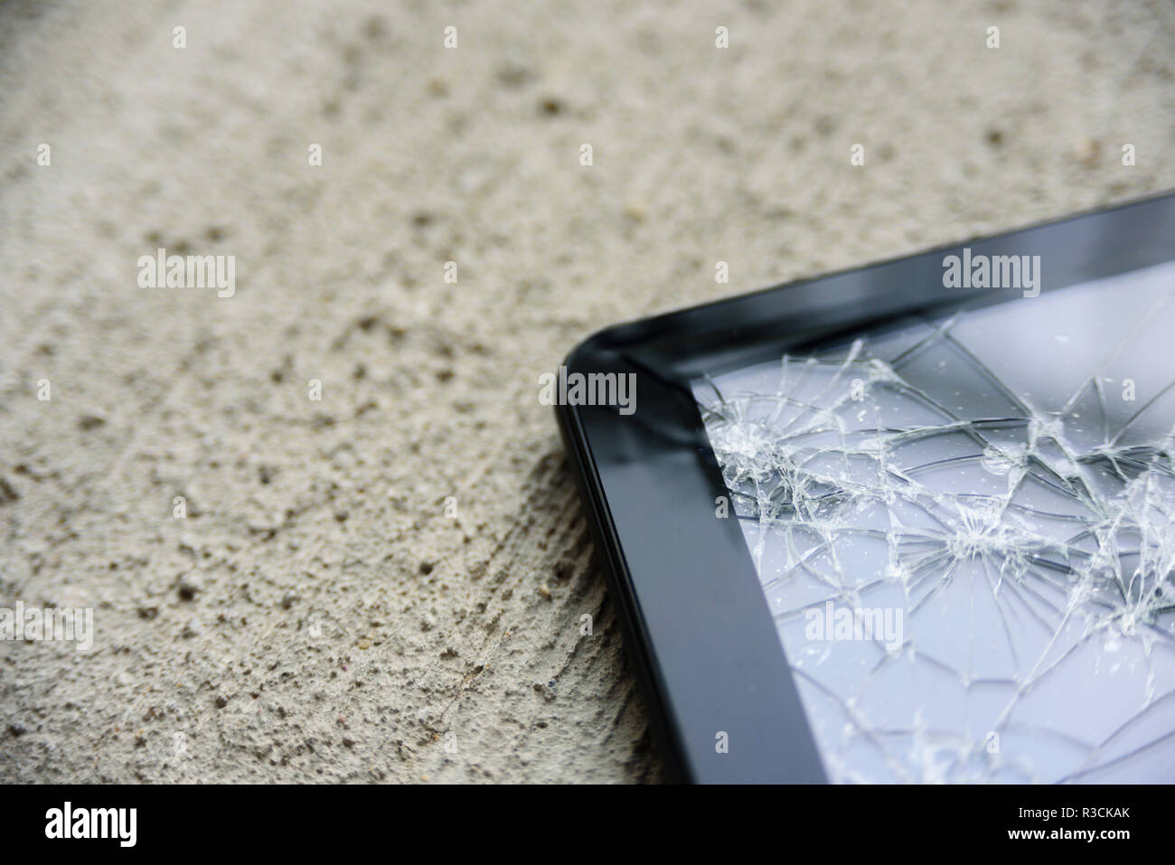 Broken tablen screen close up view on concrete background Stock Photo ...