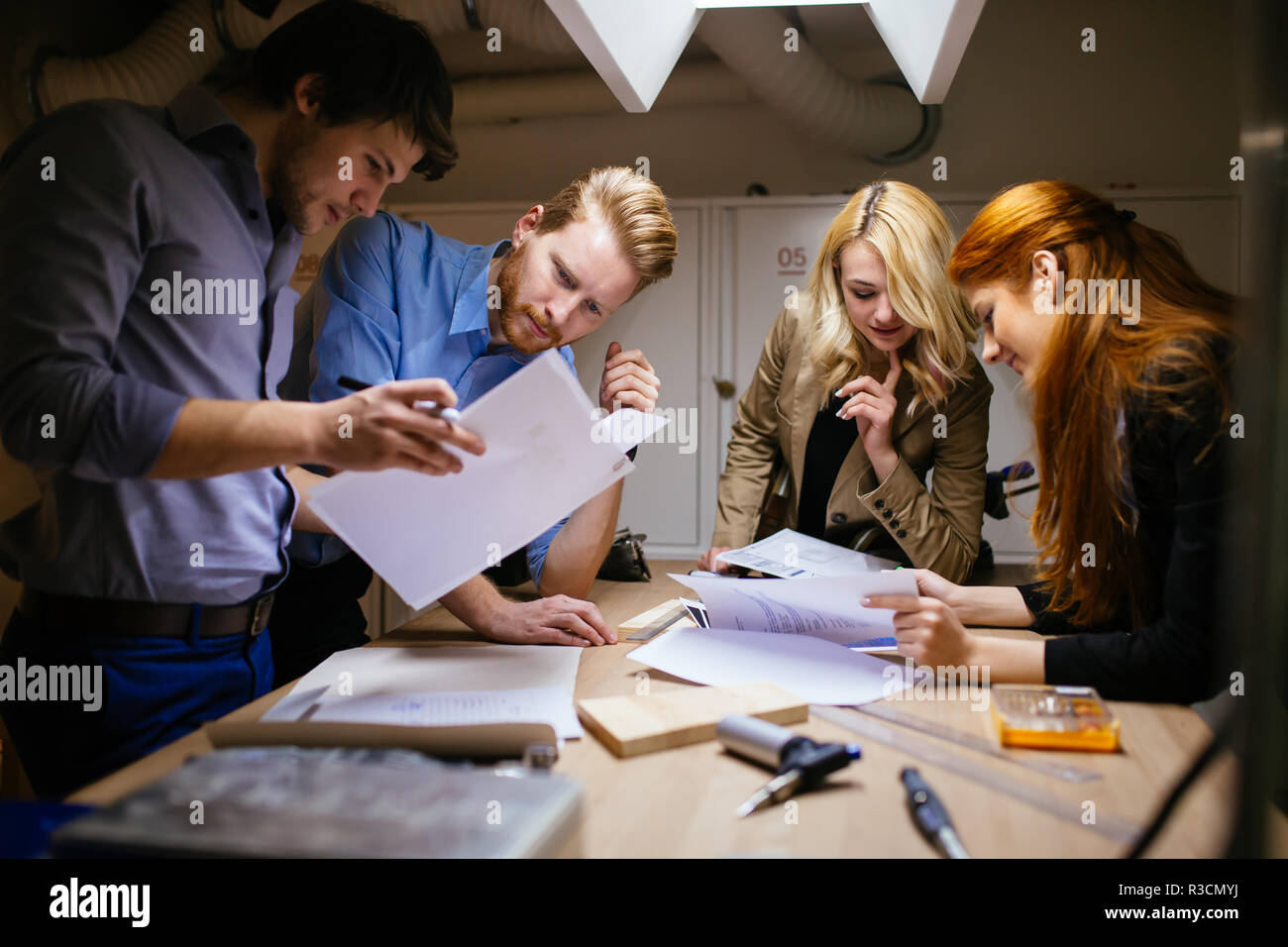 Classmates working on a project together Stock Photo - Alamy