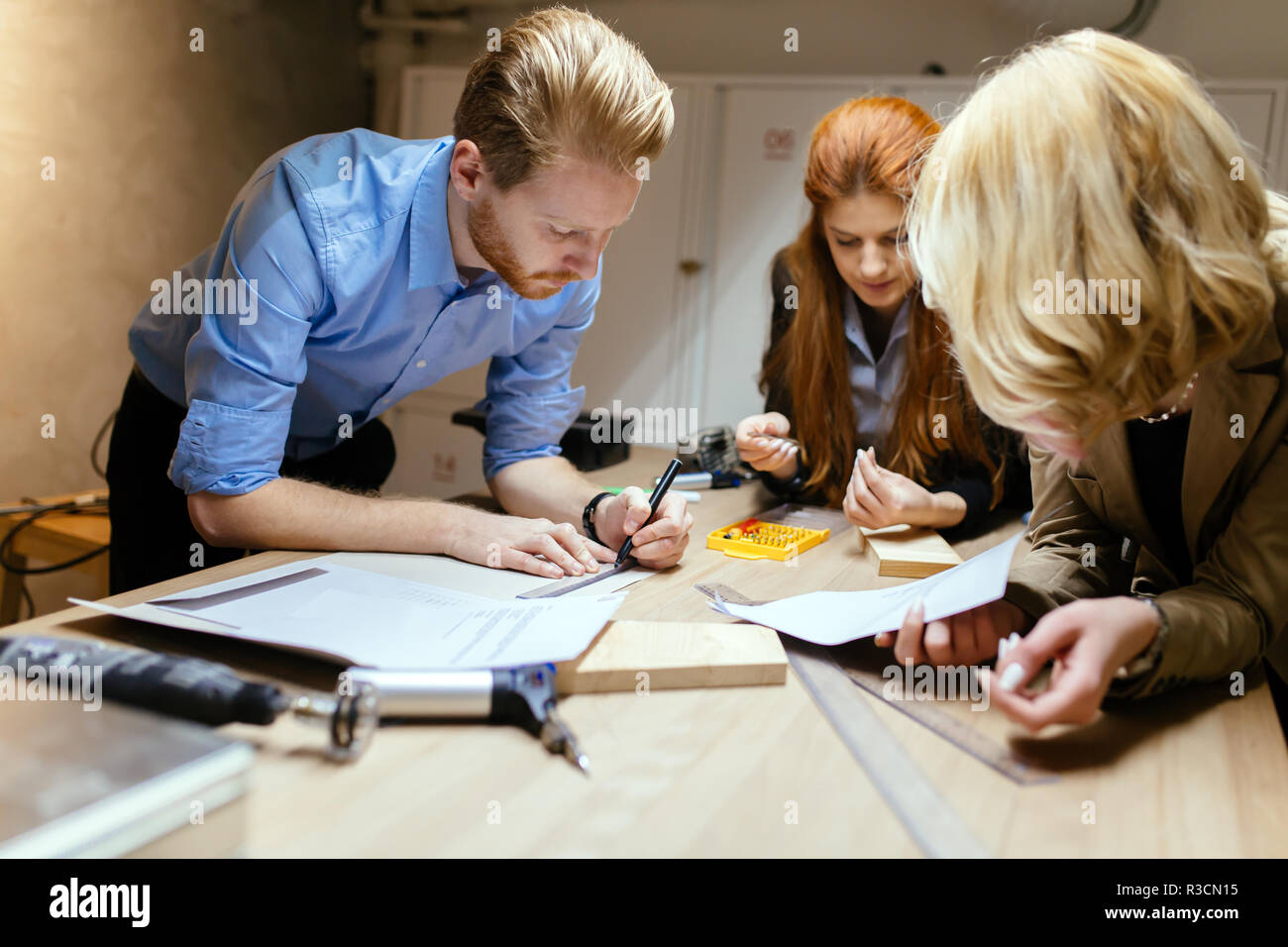 Group of designers working on a project Stock Photo - Alamy