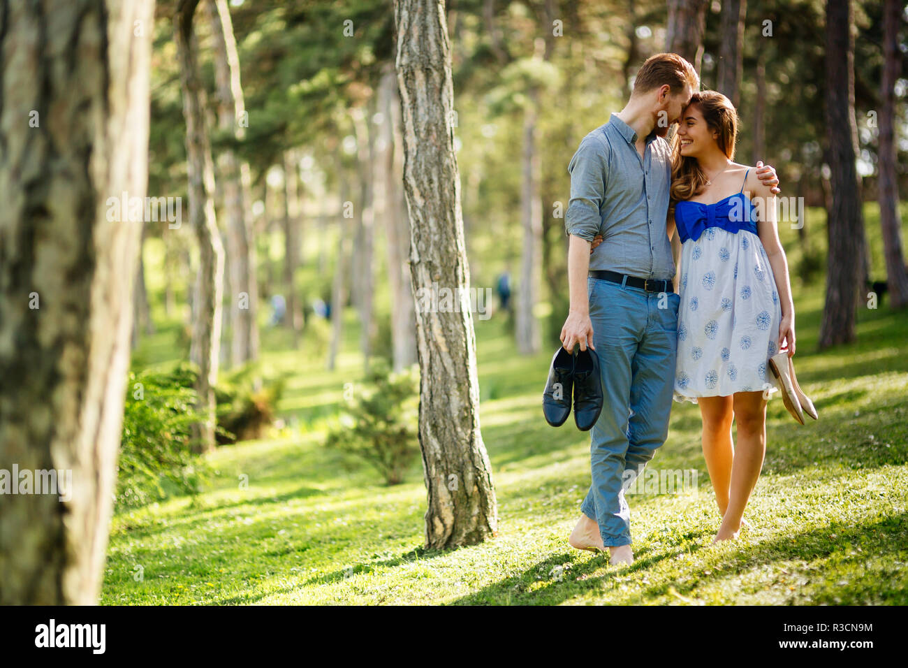 Romantic couple walking forest Stock Photo - Alamy